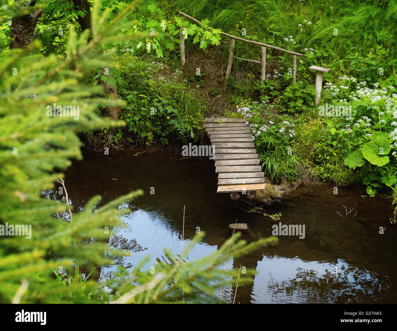 Small wooden bridge and river Stock Photo - Alamy