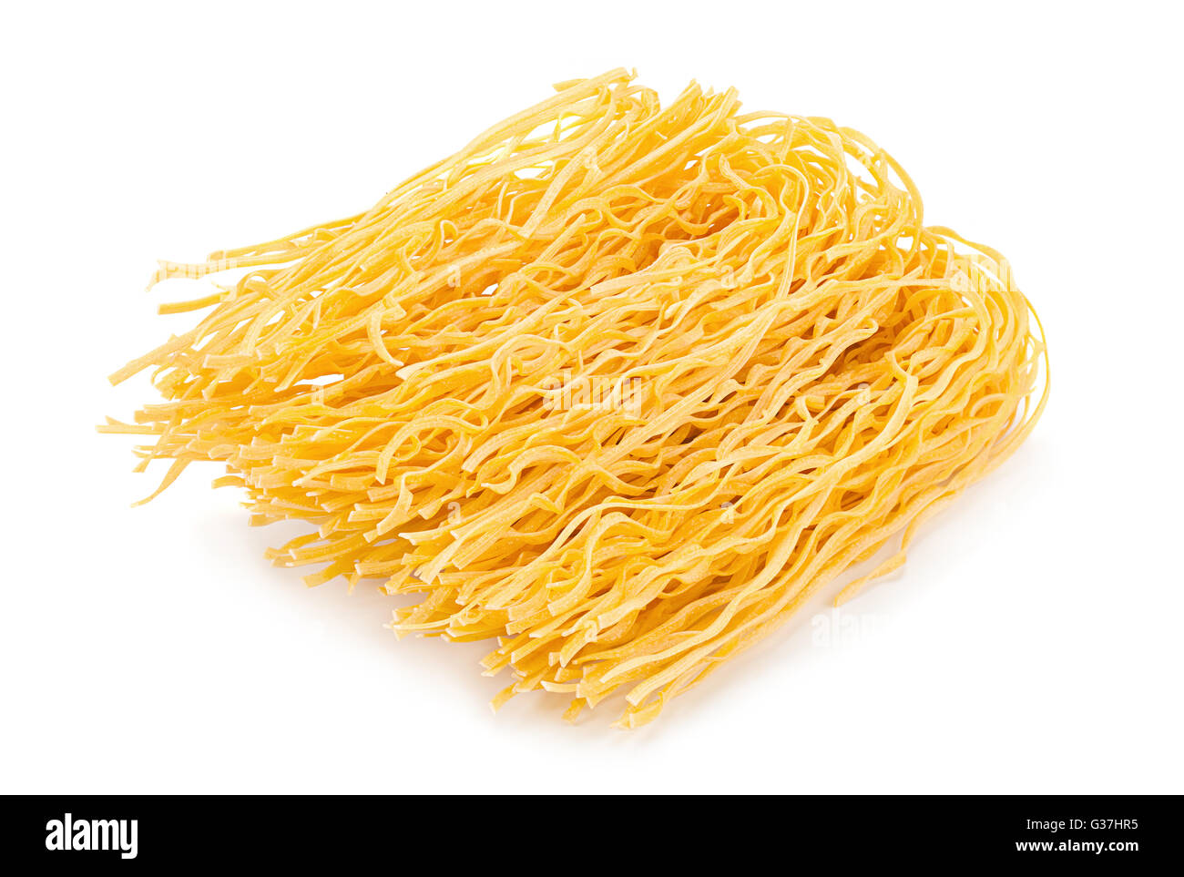 Wheat uncooked noodles isolated on white background Stock Photo - Alamy