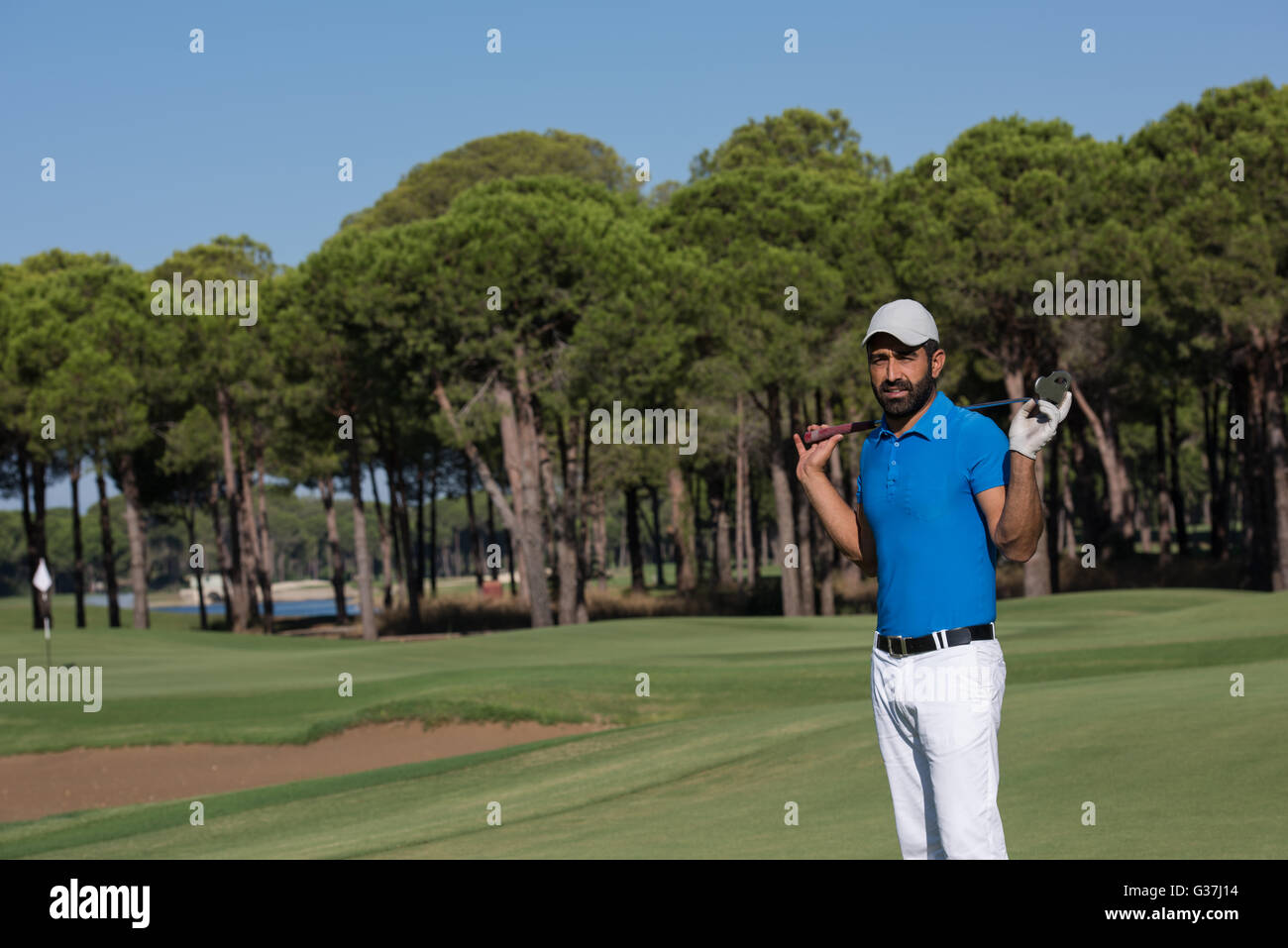 handsome middle eastern golf player portrait at course at sunny day ...