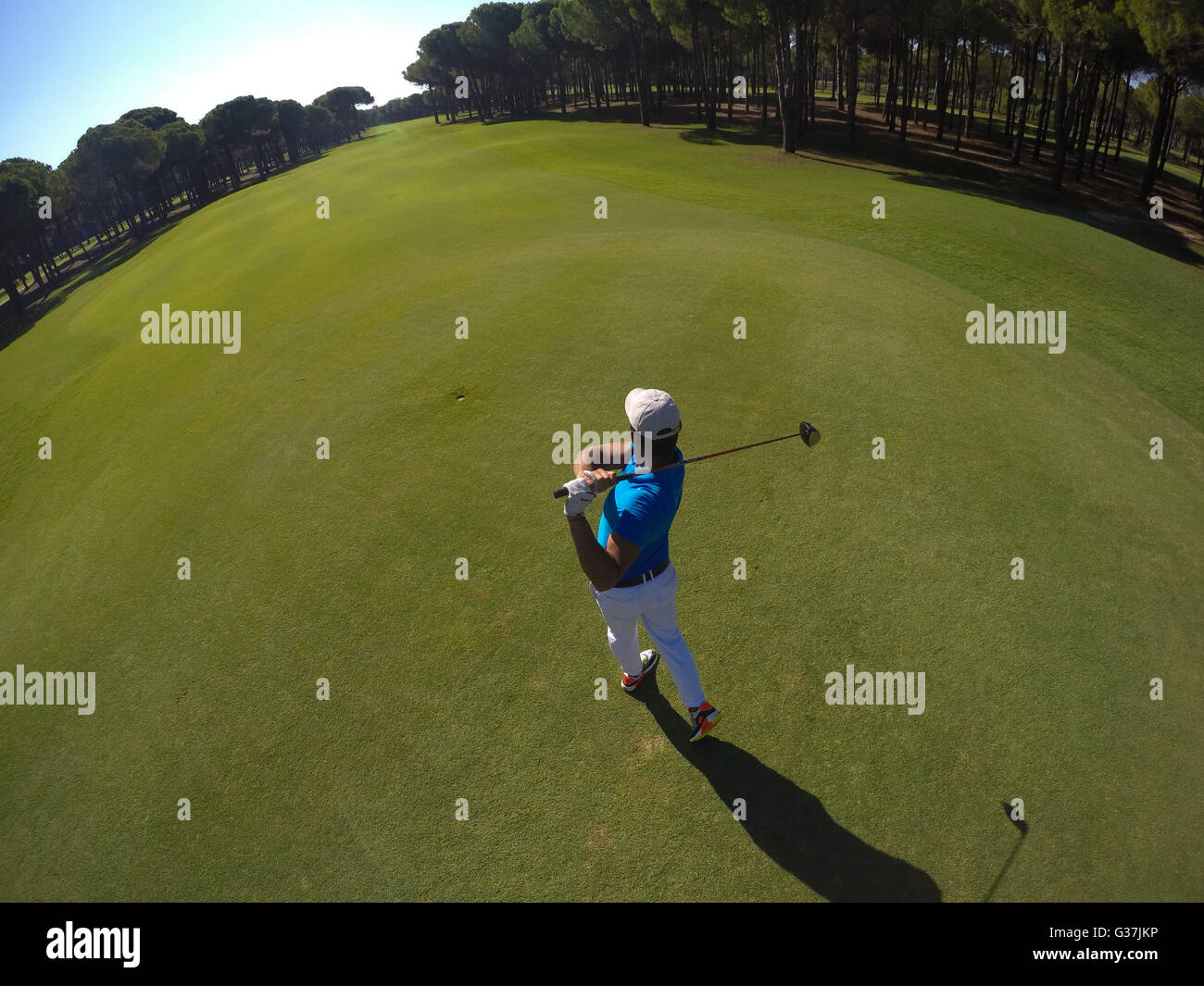 top view of golf player hitting shot with club on course at beautiful ...