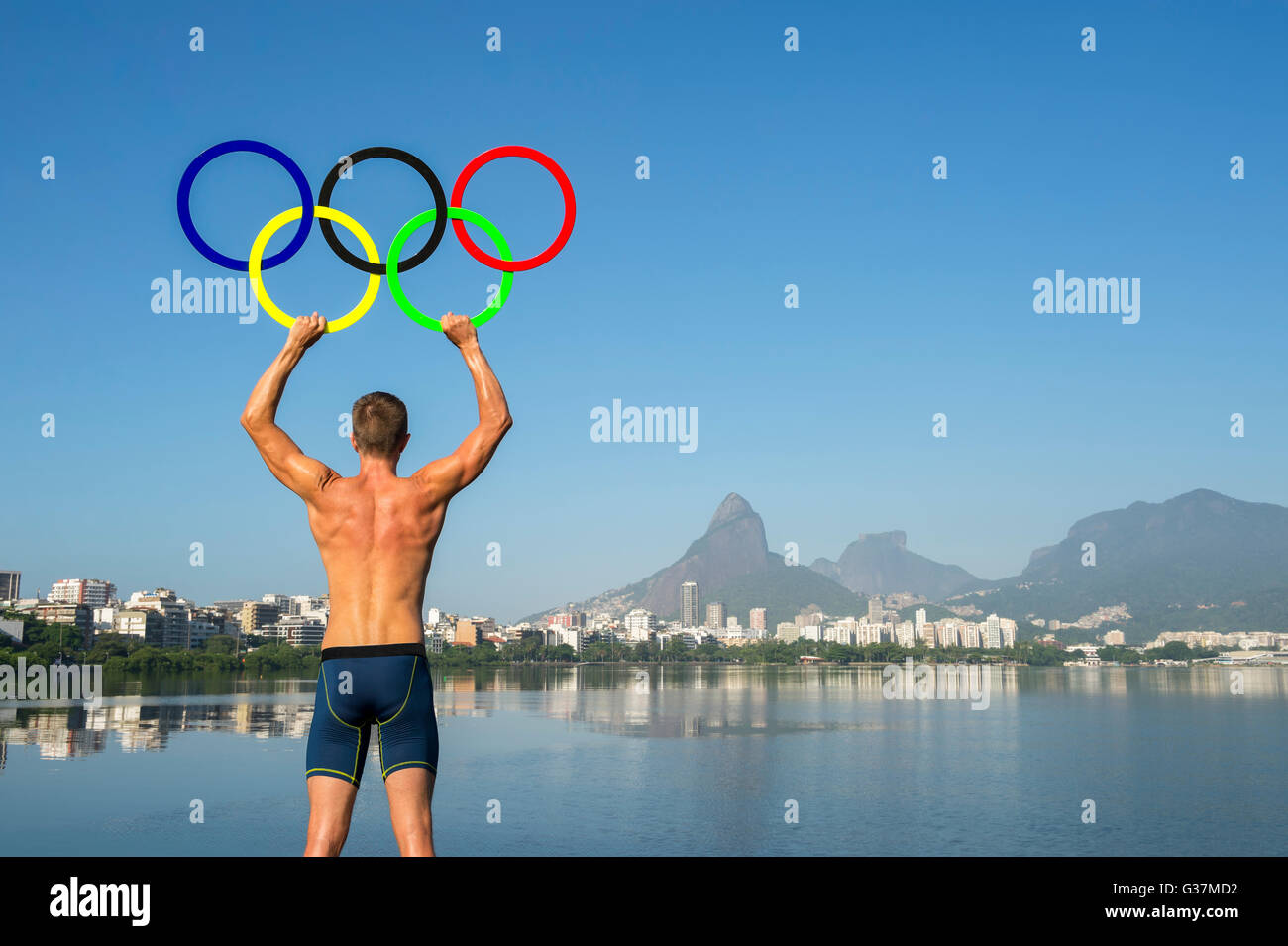 RIO DE JANEIRO - MARCH 27, 2016: Athlete swimmer holds Olympic rings at ...