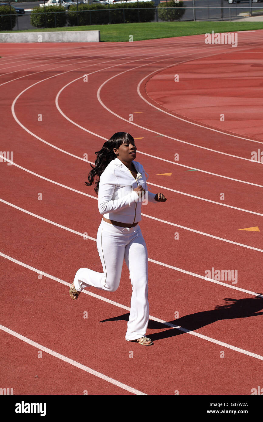 Young African American woman running on track sandals Stock Photo - Alamy