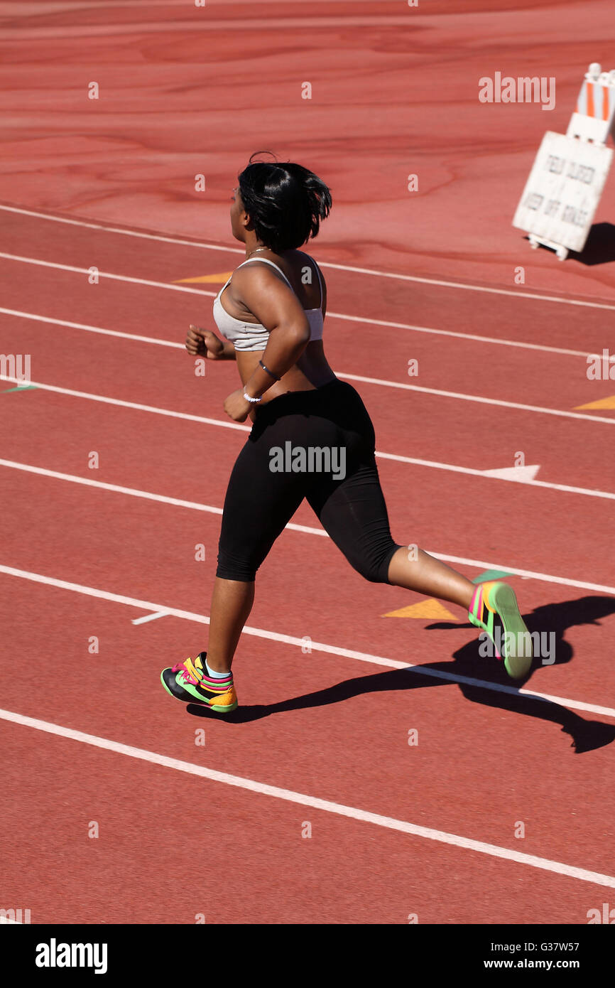 Young African American woman running on track Stock Photo - Alamy