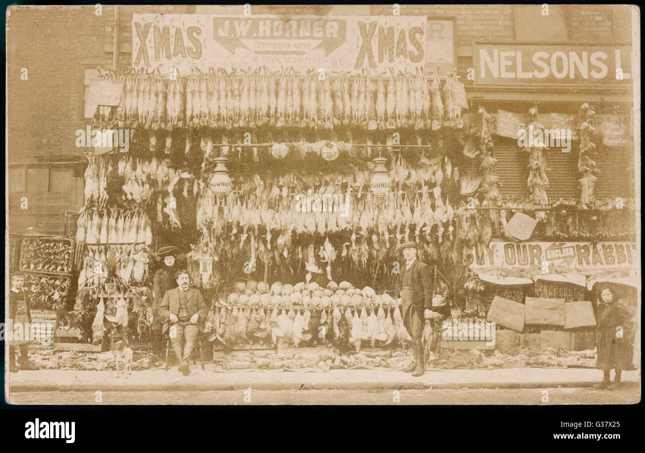 Mr Horner the Butcher sits proudly in front of his shop with its ...