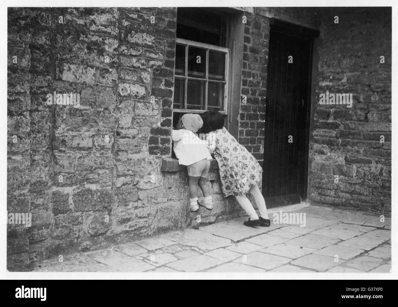 TWO CURIOUS CHILDREN Stock Photo - Alamy