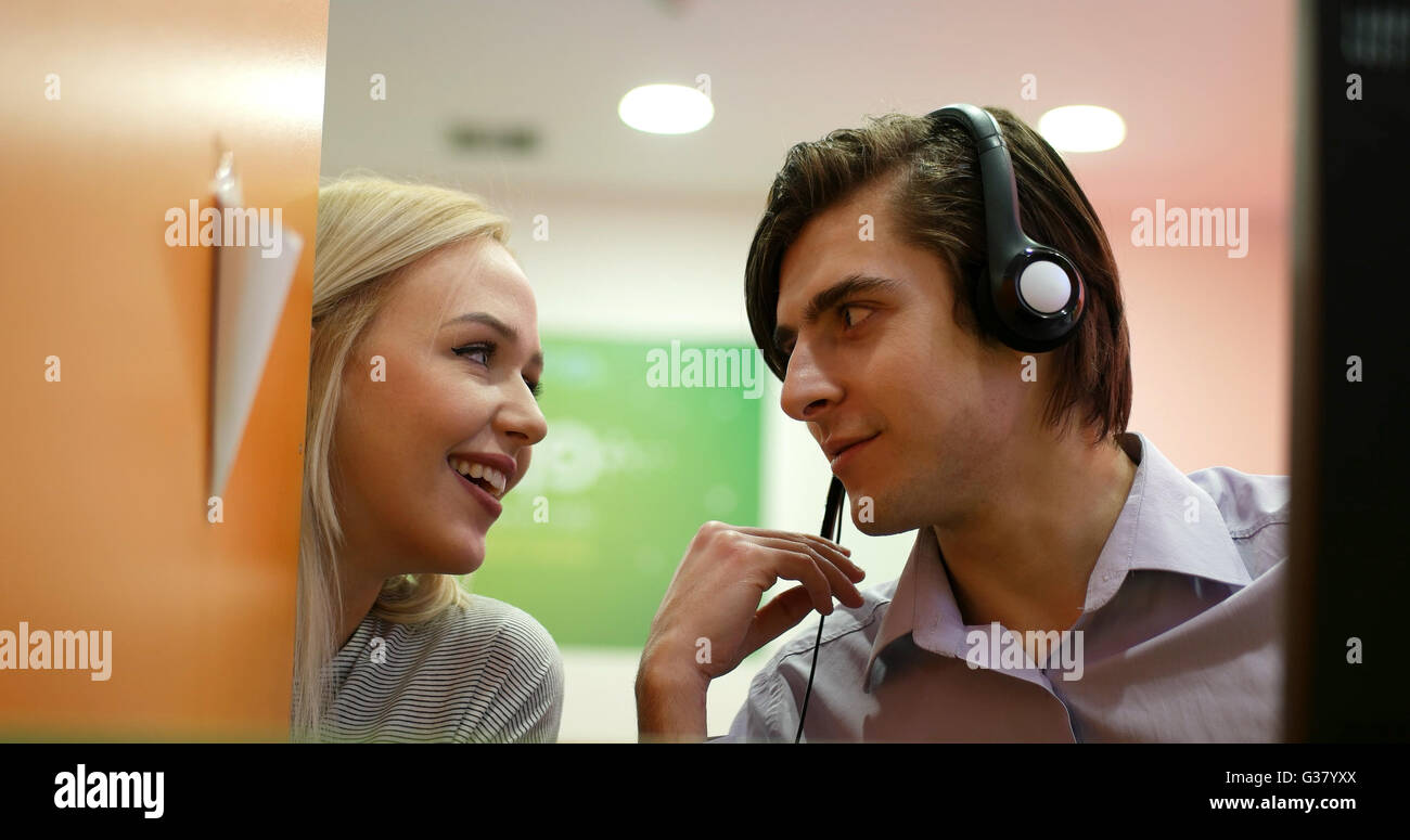 smiling office workers in a call center with phones Stock Photo - Alamy