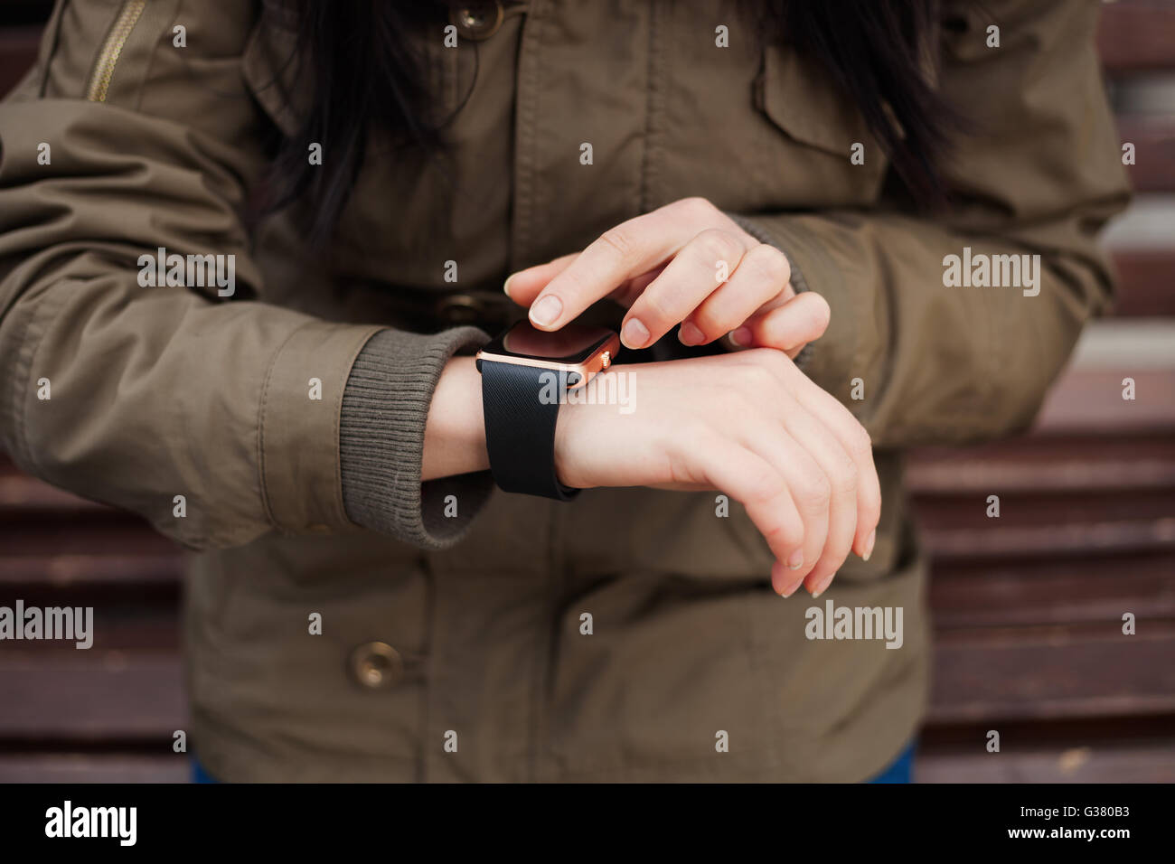 Woman clicking her smart watch on hand. This new gadget lets you always ...