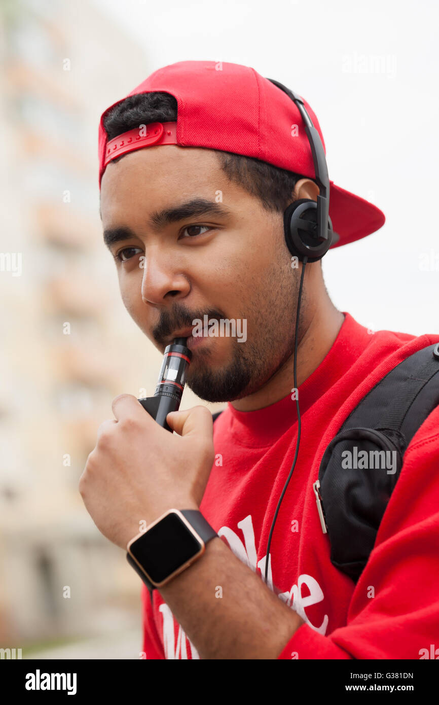 Young african man smoking e cigarette hi-res stock photography and ...