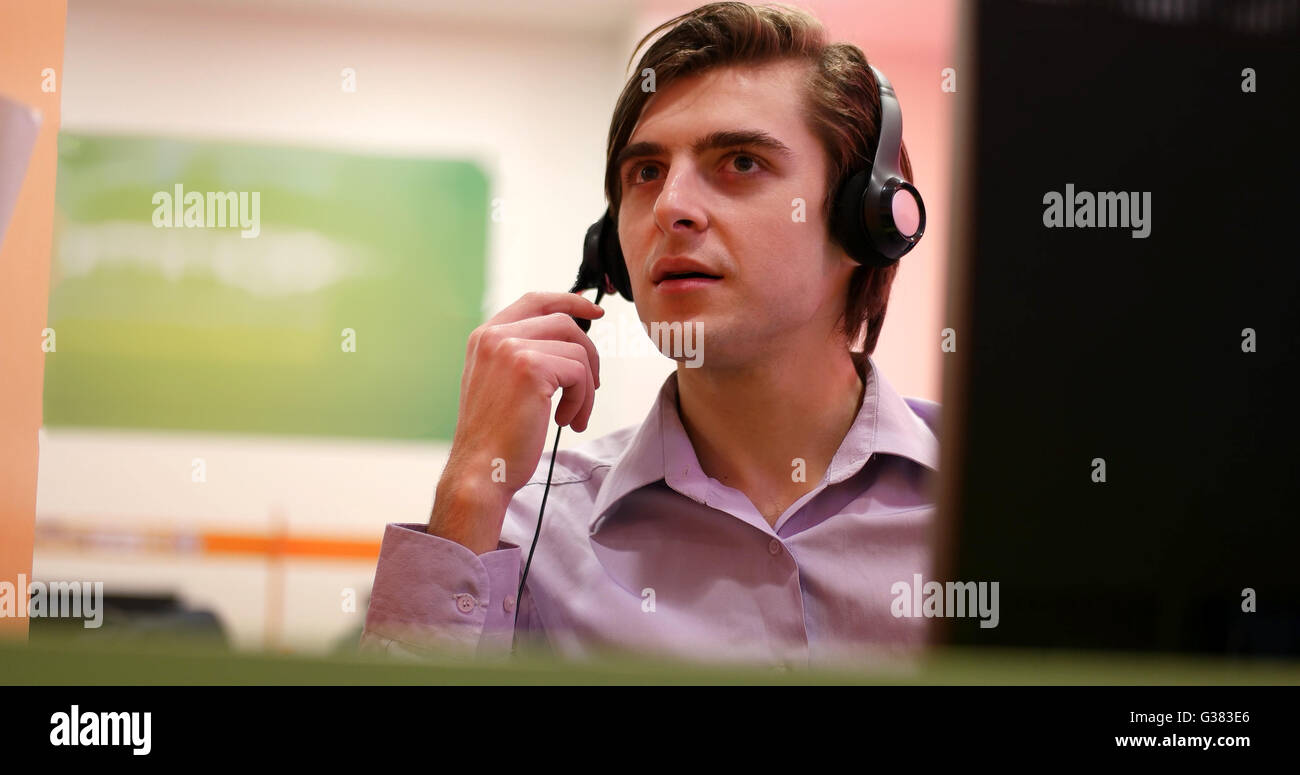 Portrait of confident male customer service representative with headset ...