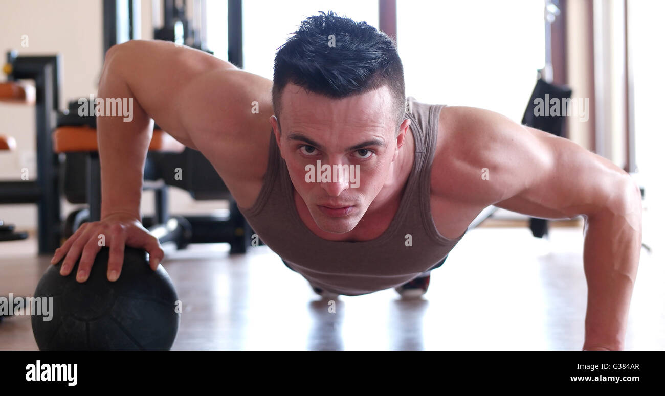 Portrait of a handsome man doing push ups exercise Stock Photo - Alamy