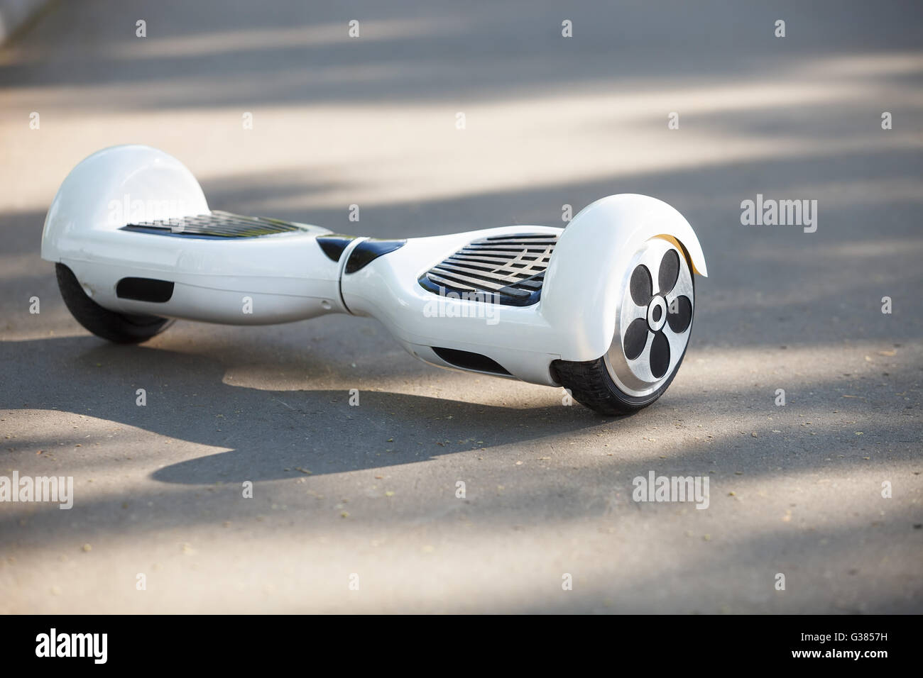 eWhite Electric mini hover board scooter on asphalt road. Eco city ...