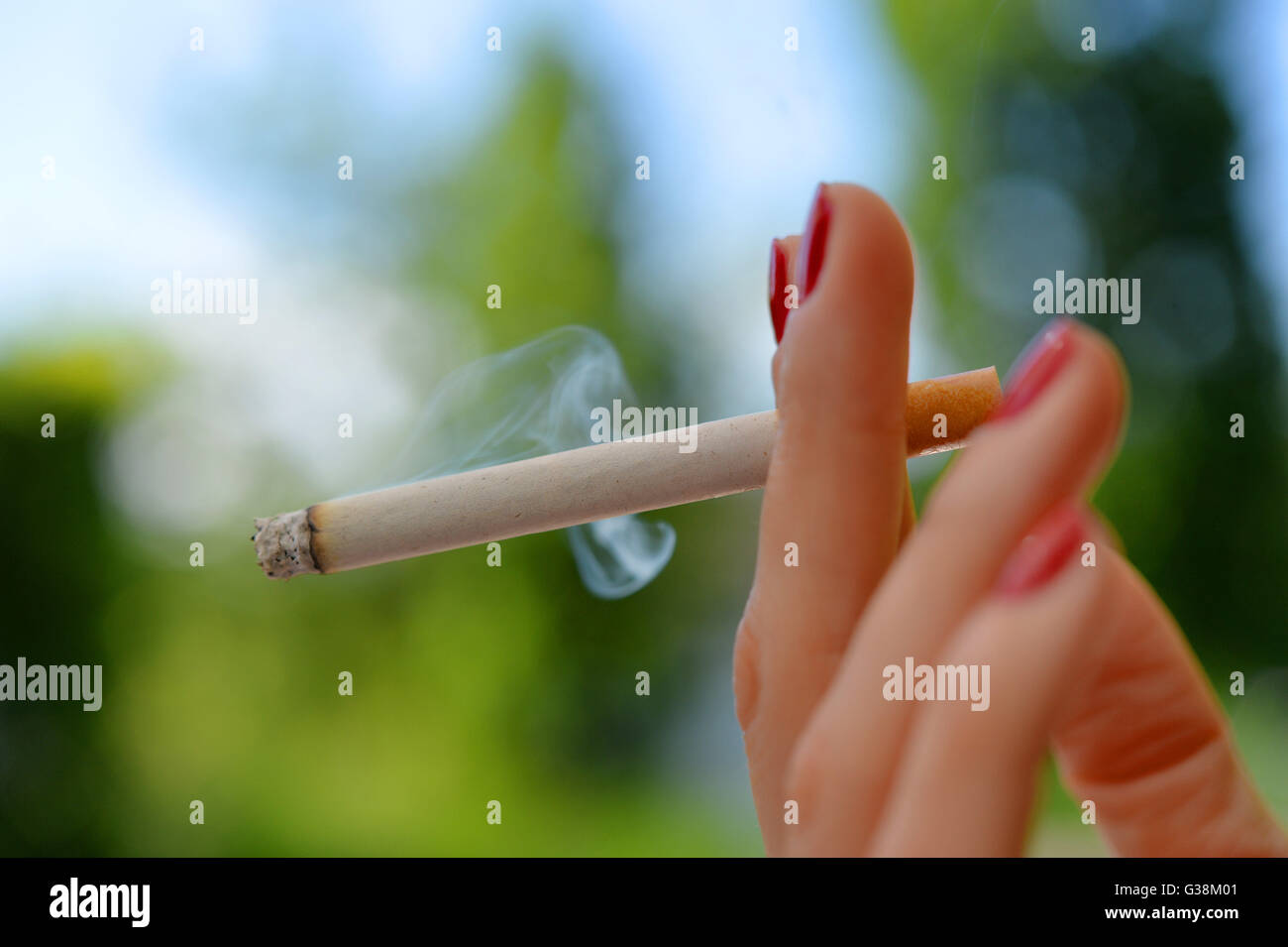 ILLUSTRATION - a woman is smoking a cigarette, Germany, city of Seesen ...