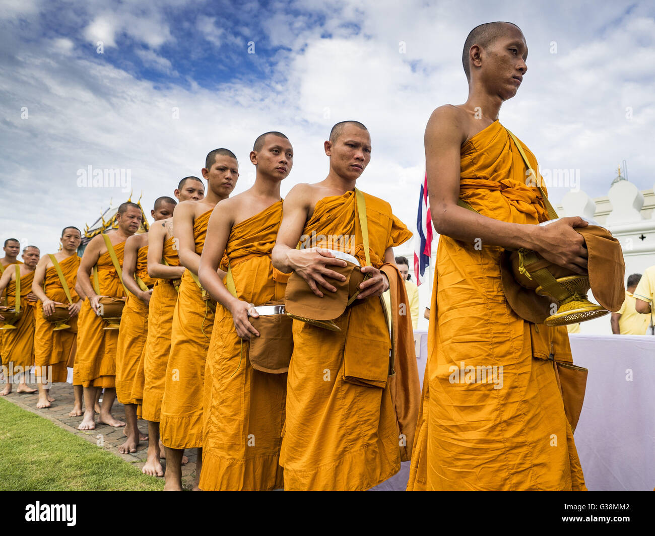 Bangkok, Thailand. 9th June, 2016. Buddhist monks file past alms givers ...