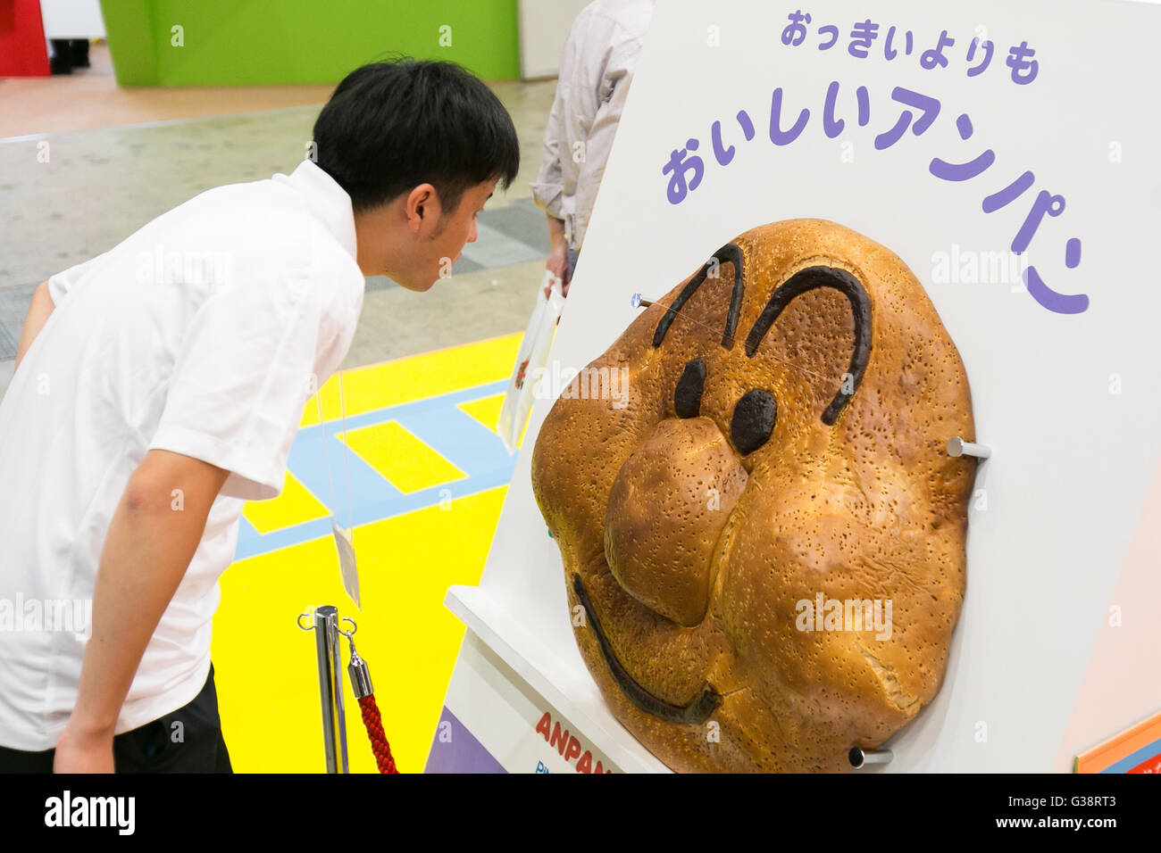A visitor looks at a huge Anpanman character shaped bread on display at ...