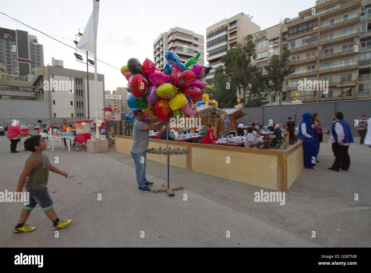 Beirut, Lebanon. 9th June, 2016. A man carries balloons as Muslim ...
