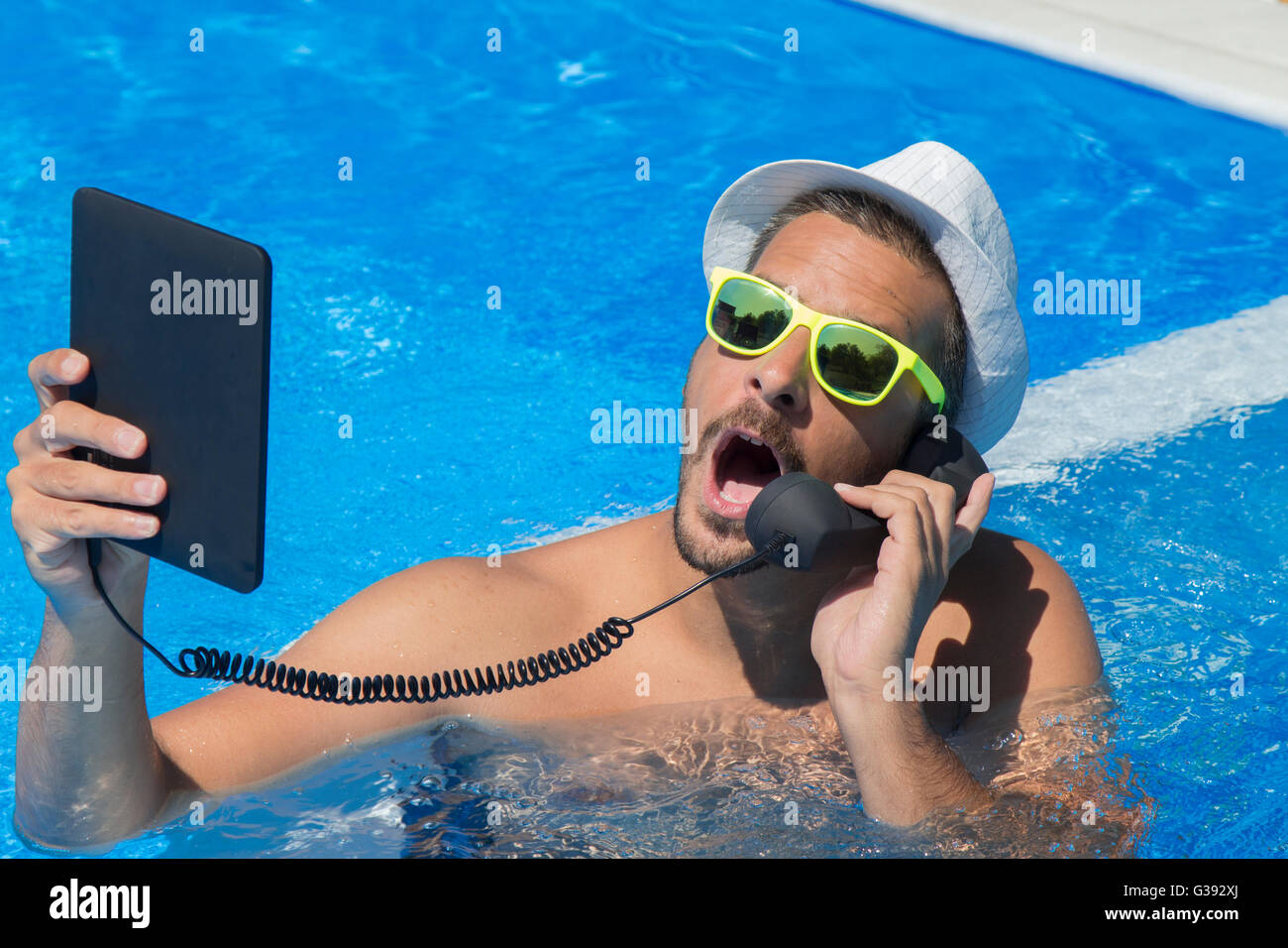 Guy having a call from a swimming pool Stock Photo - Alamy