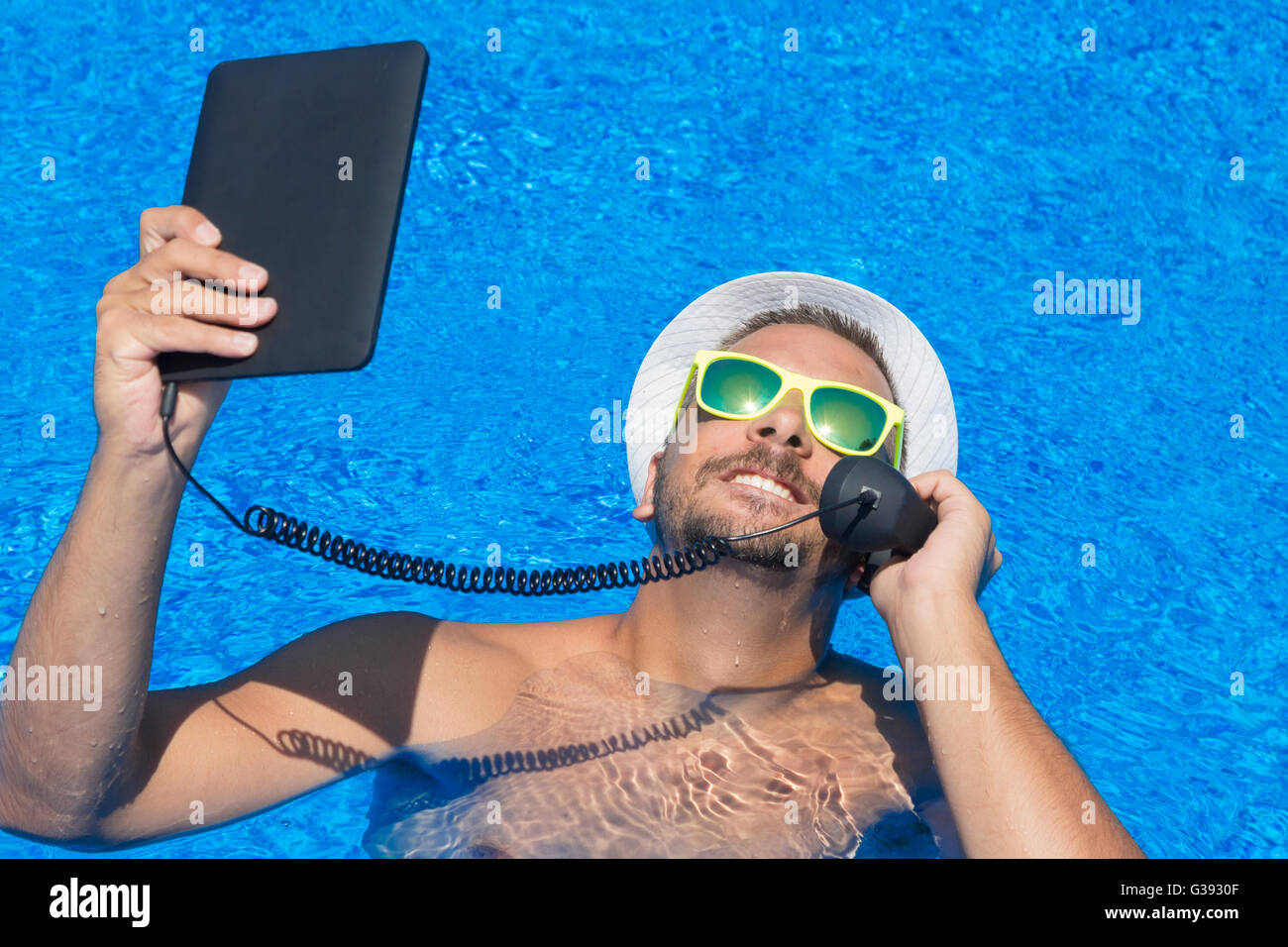 Guy having a call from a swimming pool Stock Photo - Alamy