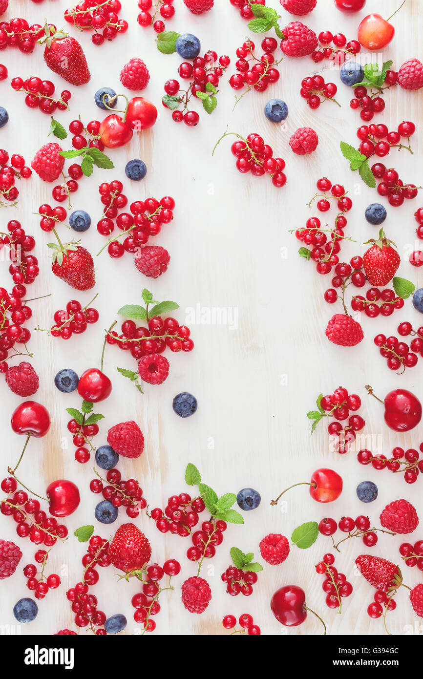 Summer fruit background. Fresh organic berry fruit scattered on rustic ...