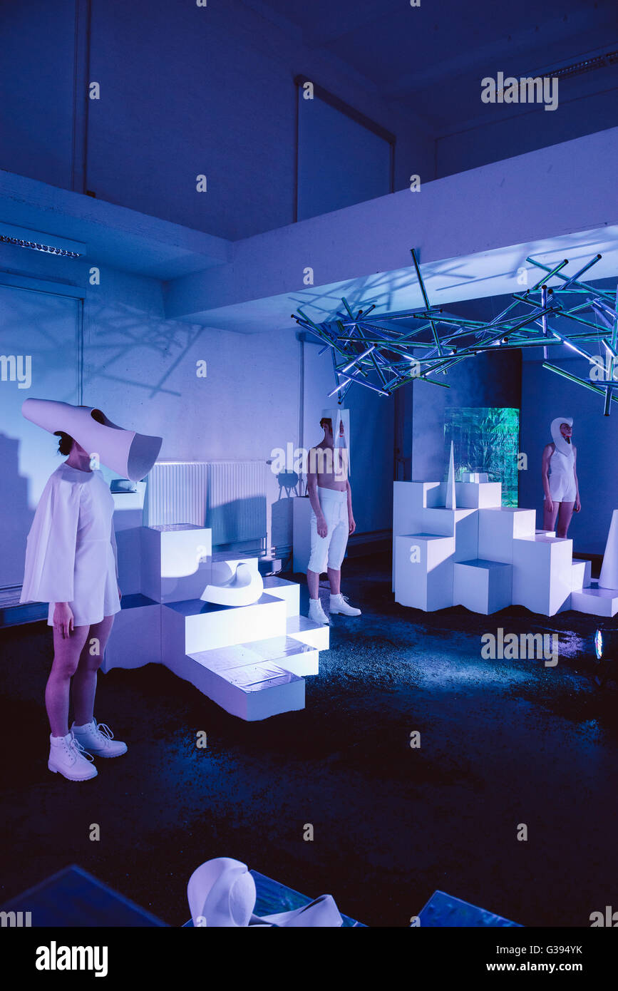 Models with spacey porcelain hat in blue show room Stock Photo - Alamy