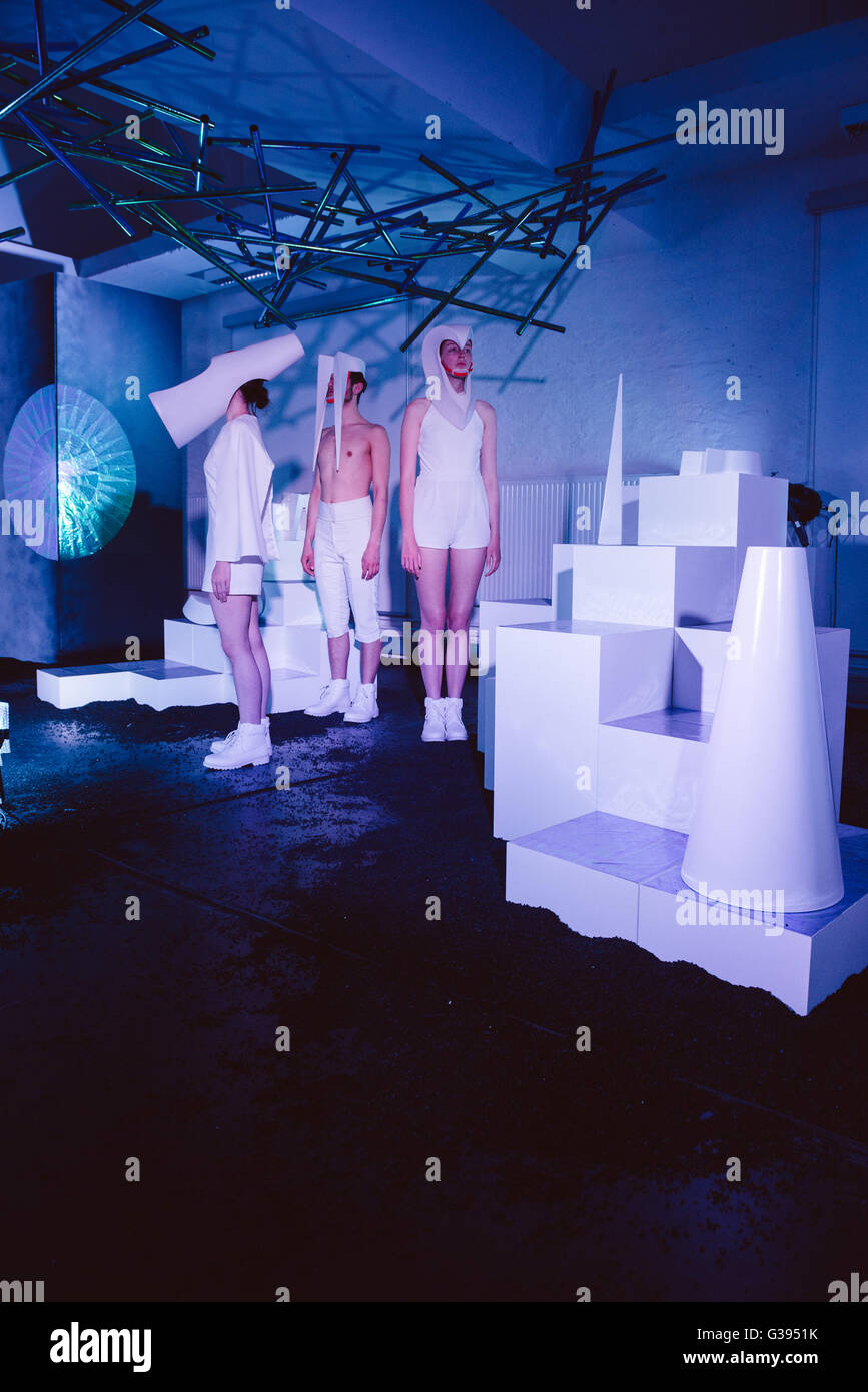 Models with spacey porcelain hat in blue show room Stock Photo - Alamy