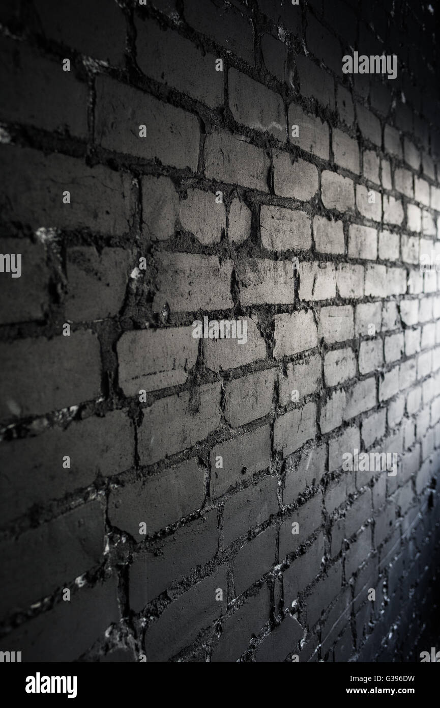 Side view on black brick wall lit by light from the window Stock Photo ...