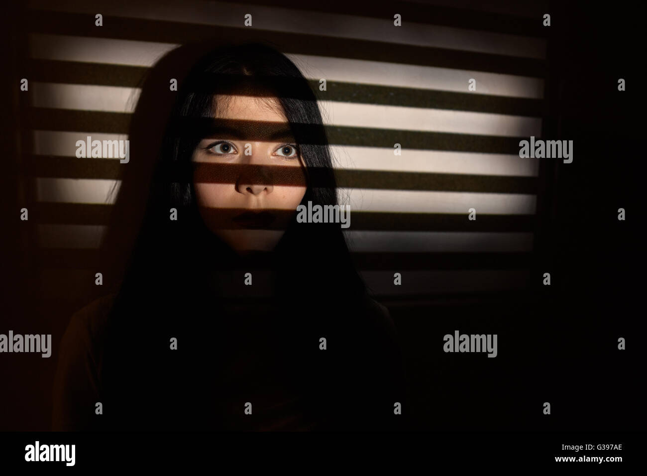 sad scared female portrait in dark with copyspace Stock Photo - Alamy