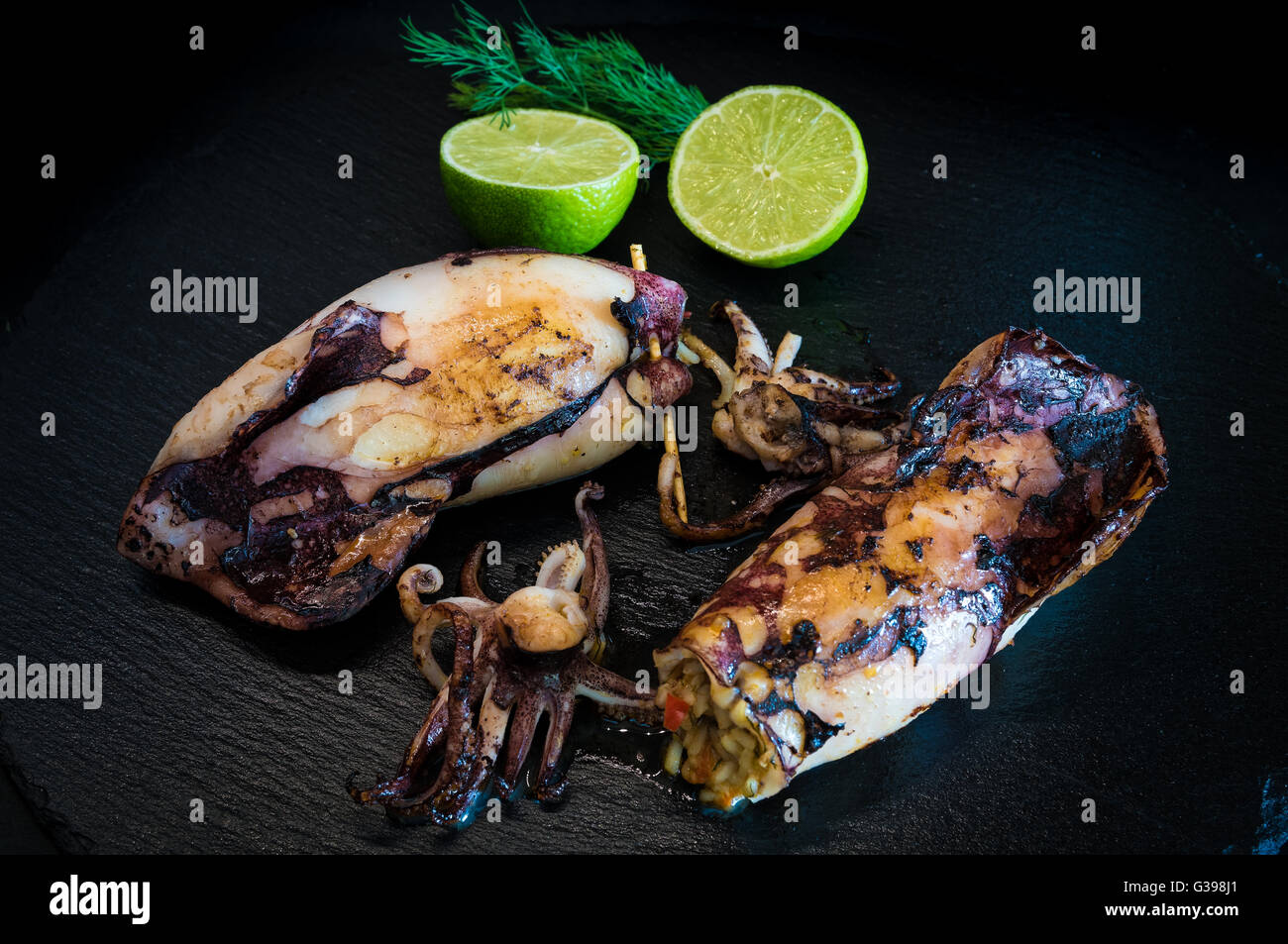 Fried squid, stuffed with rice on black dish Stock Photo - Alamy