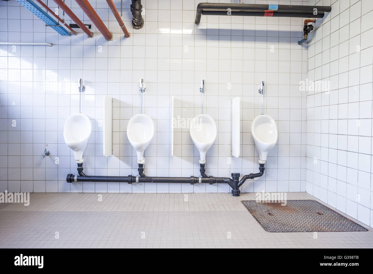 urinals in an old building for men only Stock Photo - Alamy