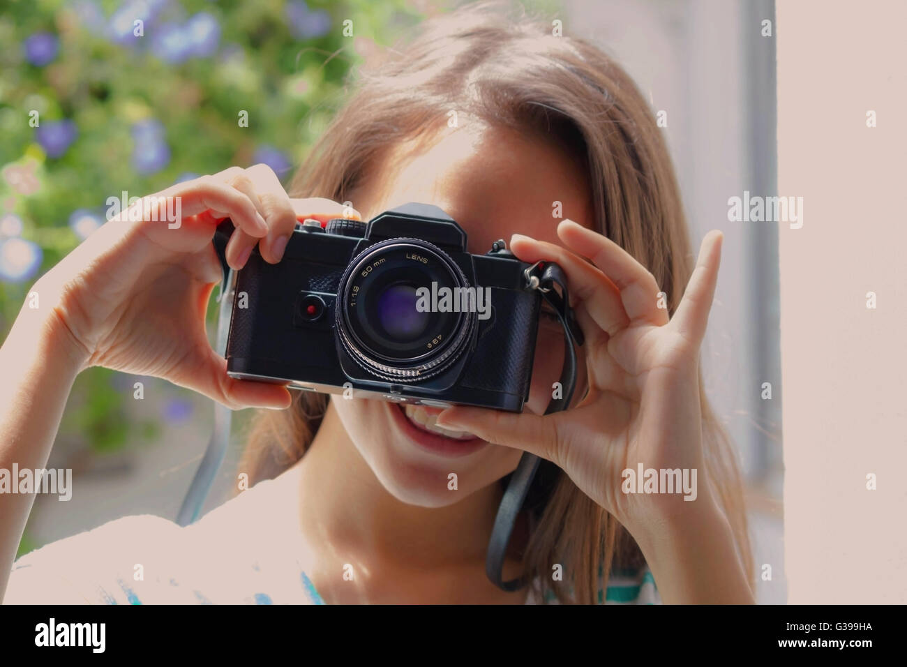 Teenagers taking pictures of retro camera Stock Photo - Alamy