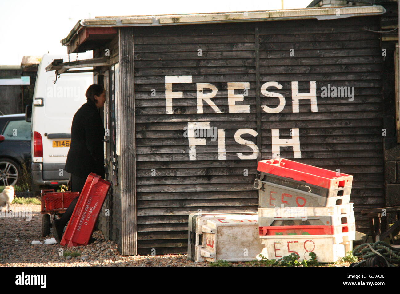 CUSTOMER BUYING FISH AT A WOODEN FRESH FISH HUT IN THE POPULAR RESORT ...