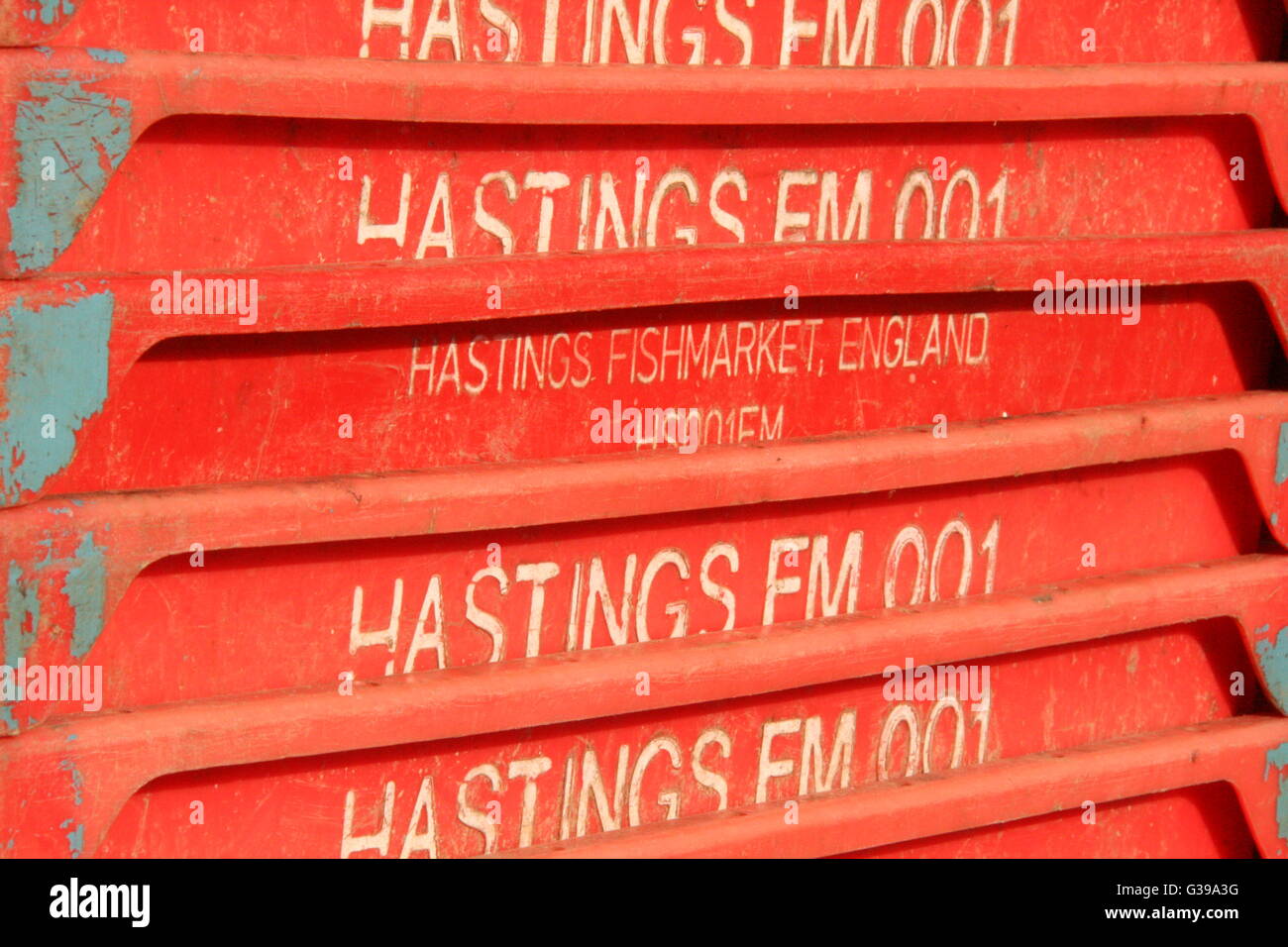 A STACK OF 6 BRIGHT RED FISHING BASKETS WITH THE HOME PORT OF HASTINGS ...