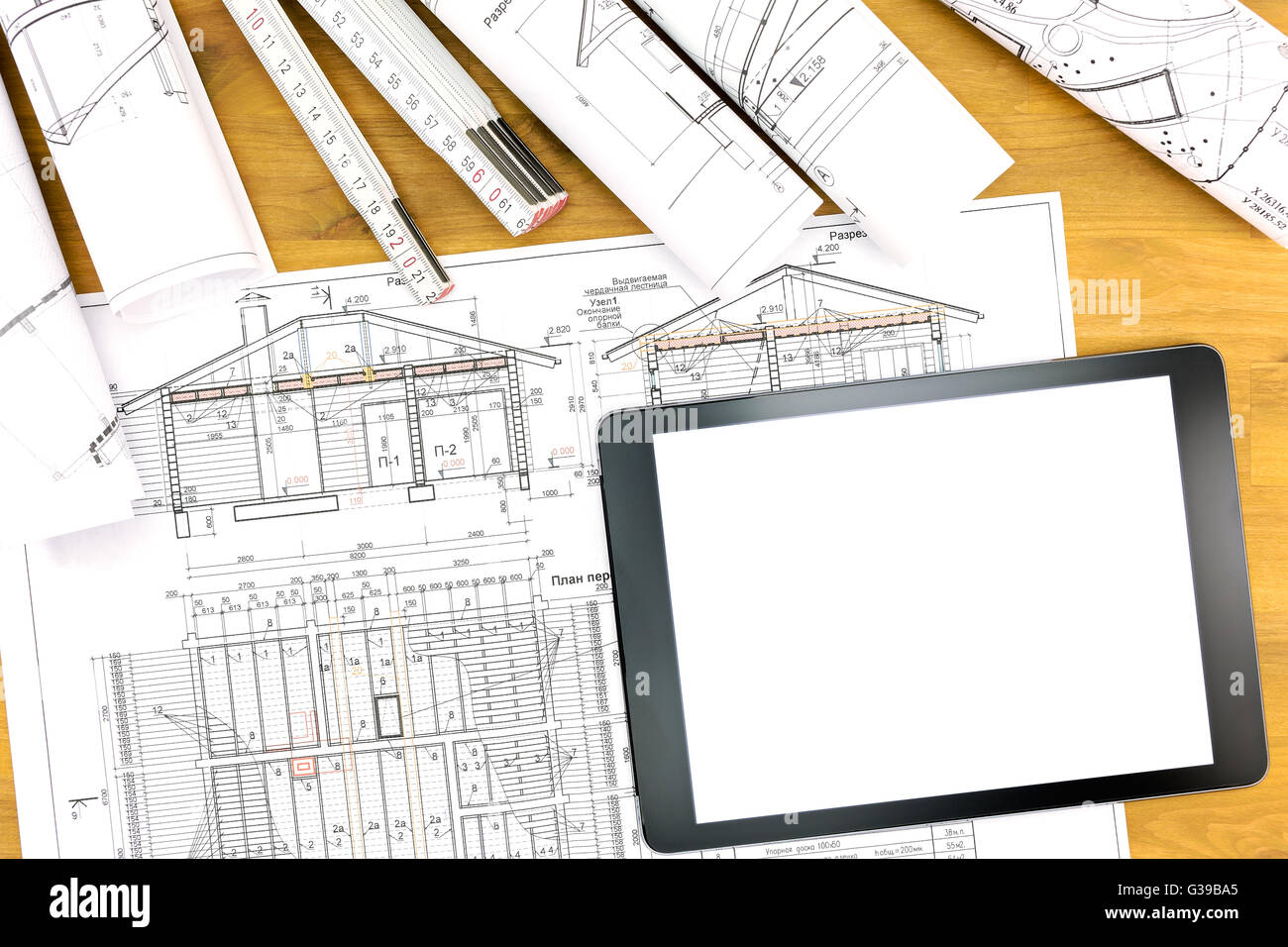 tablet computer, architectural blueprint and rolls of plans Stock Photo ...