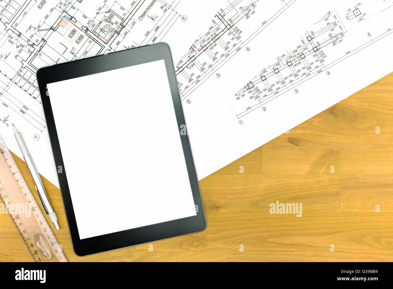 top view of tablet computer with pencil and rule over blueprints Stock ...