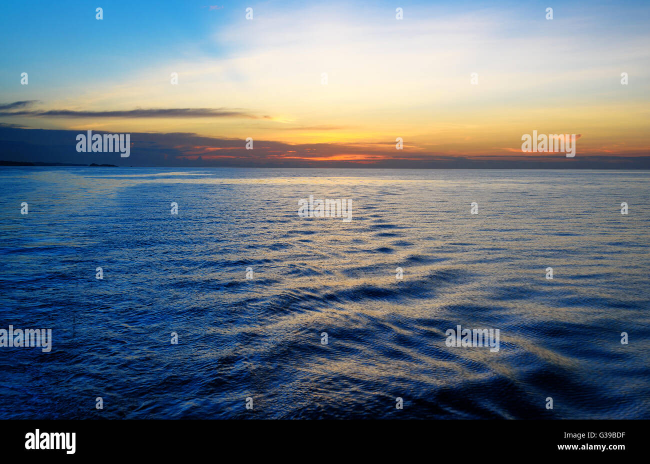 Beautiful sunset at the equator. View from ferry Stock Photo - Alamy