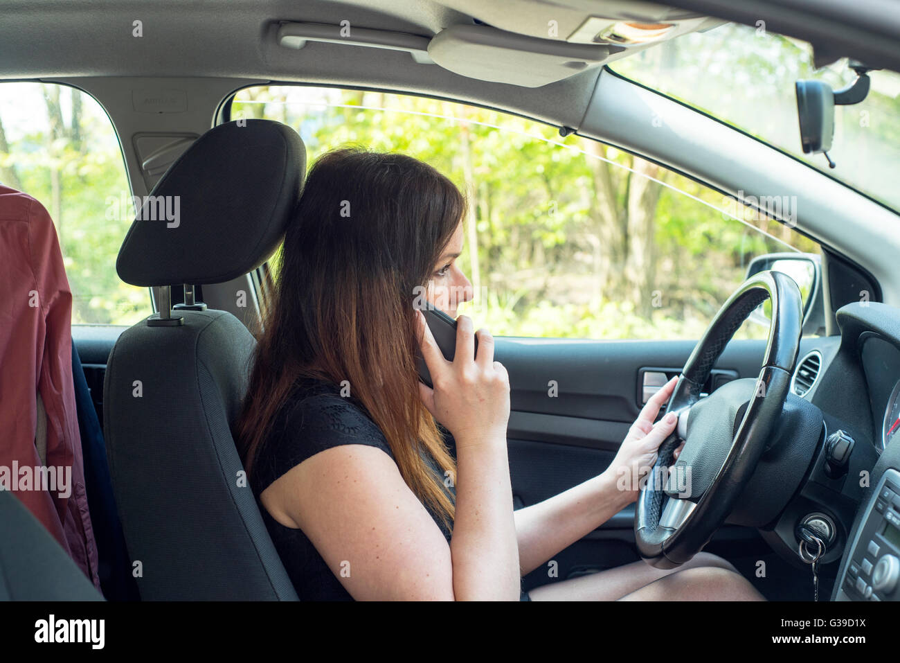 image depicting a woman riding in a car and talking on the phone Stock ...