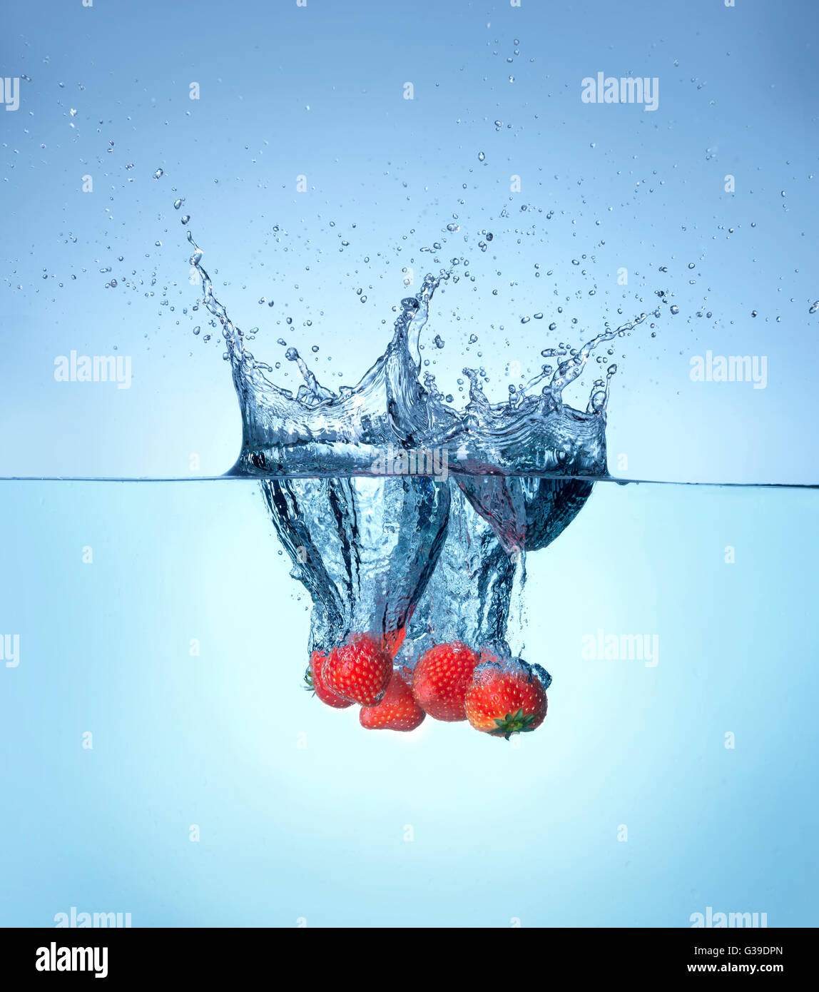 strawberry falling and splashing into water Stock Photo - Alamy