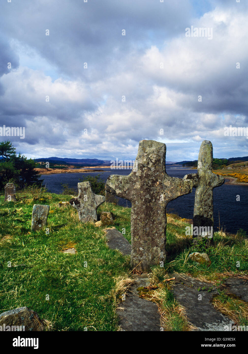 An Early Medieval incised cross-slab stands beside three megalithic ...
