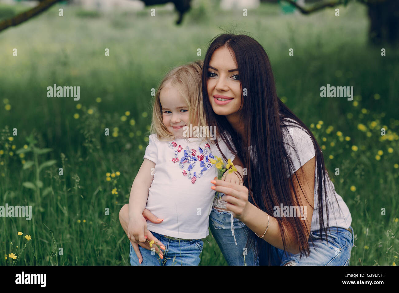 child near tree with mom Stock Photo - Alamy
