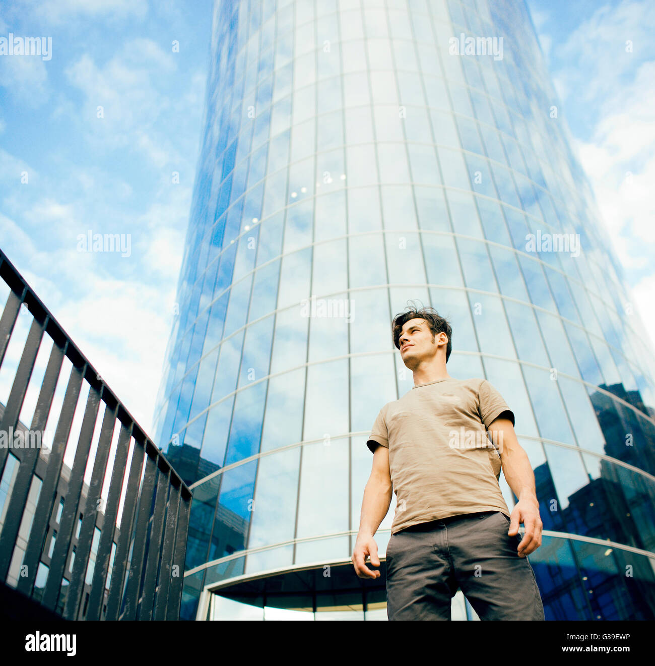real young man stand in front of modern business building Stock Photo ...