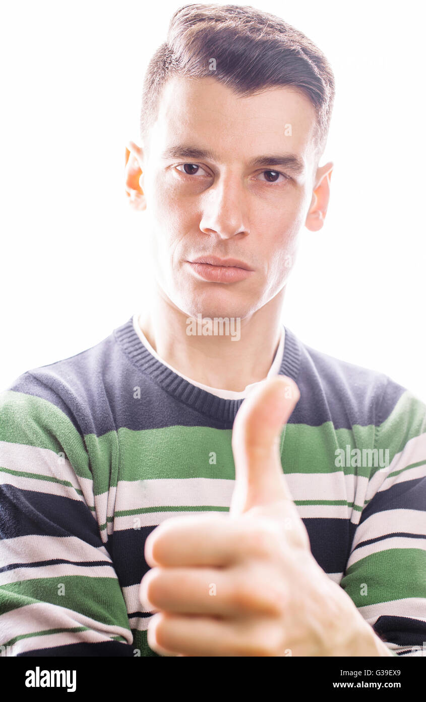 Portrait of a smart serious young man standing against white background ...