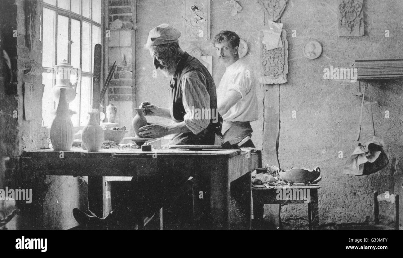 One old man and one young man turning pottery in a French factory. Date ...