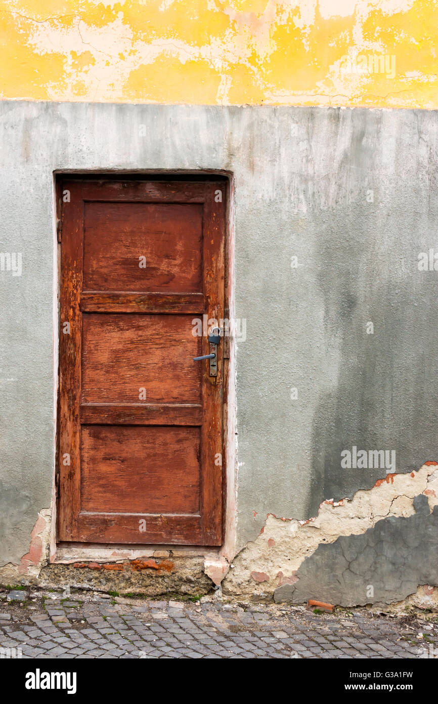 old wooden door frame with lock granary on the old cracked wall Stock ...