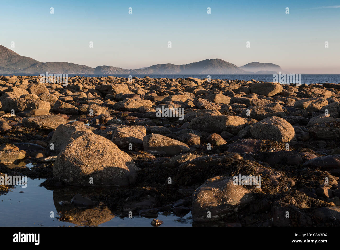 Rocks and rock pools in evening light Waterville Beach County Kerry ...