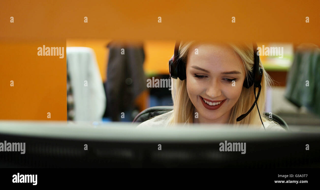 Attractive young woman in suit sitting at call center office and ...