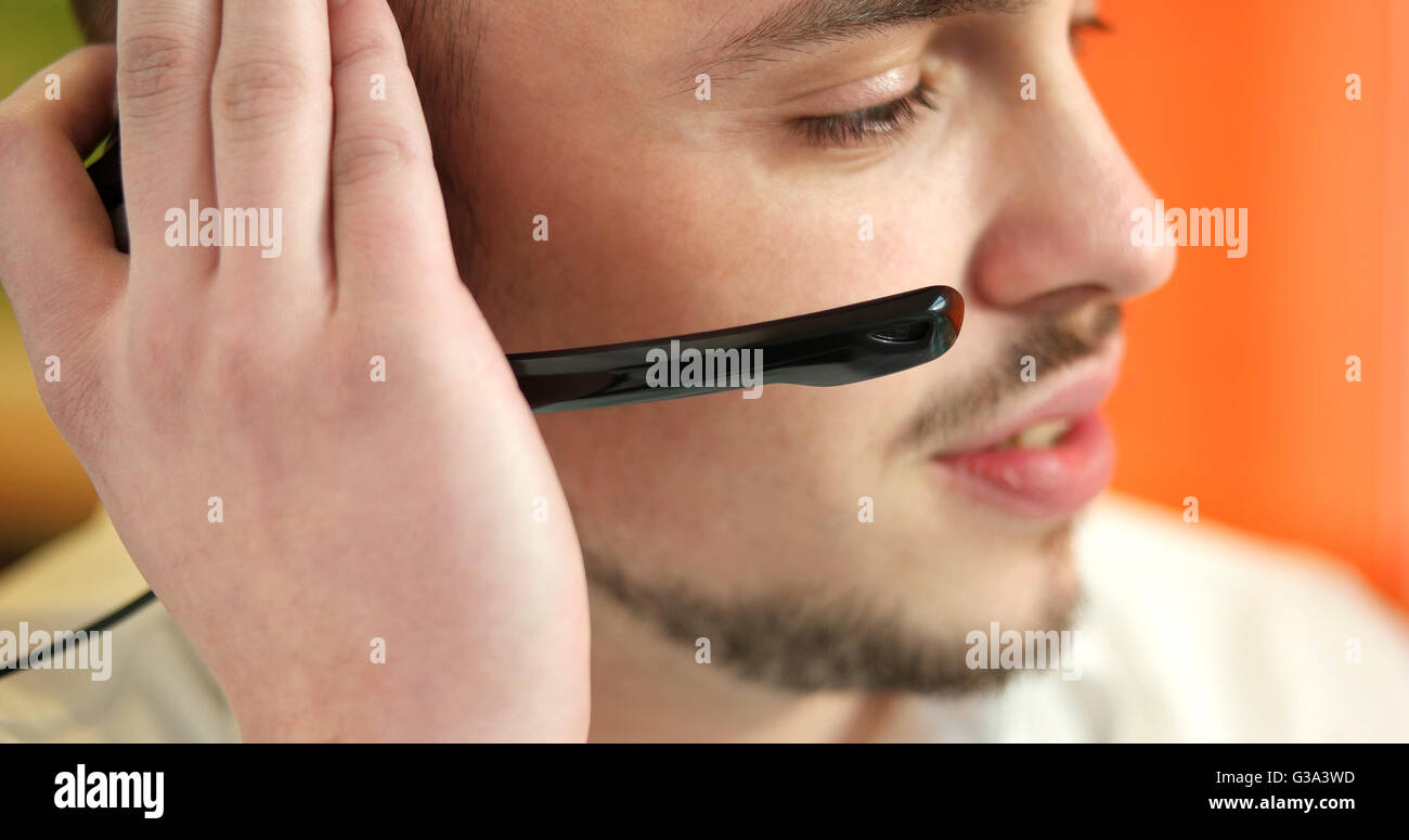 Portrait of confident male customer service representative with headset ...