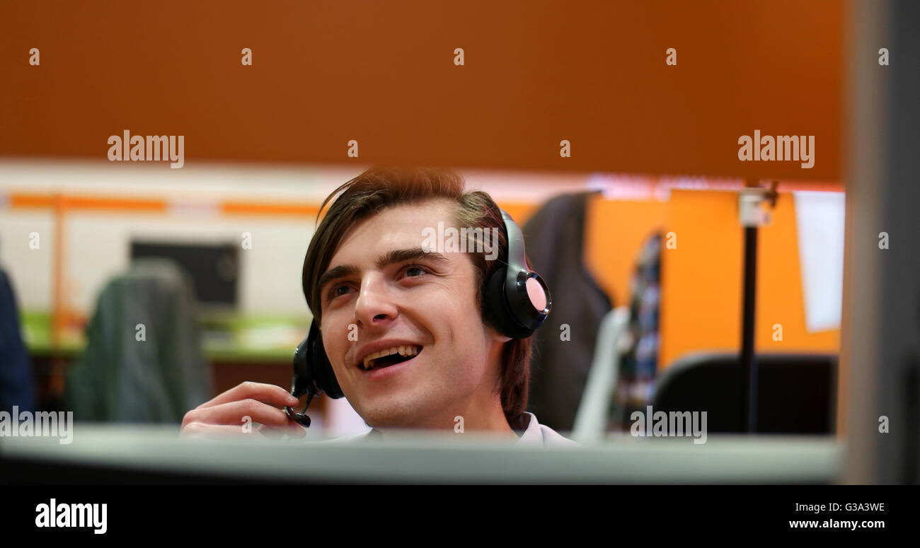 Portrait of confident male customer service representative with headset ...