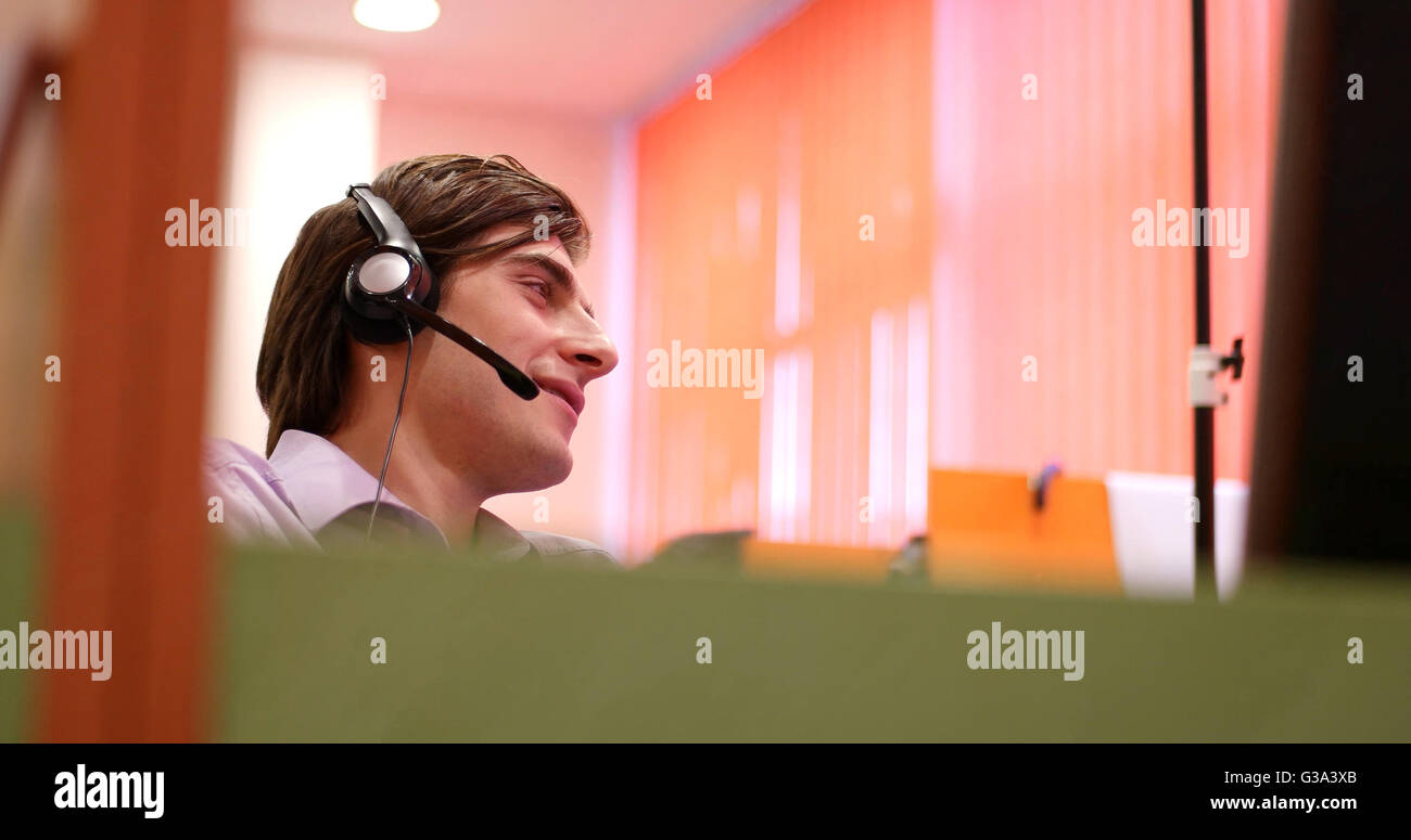 Portrait of confident male customer service representative with headset ...