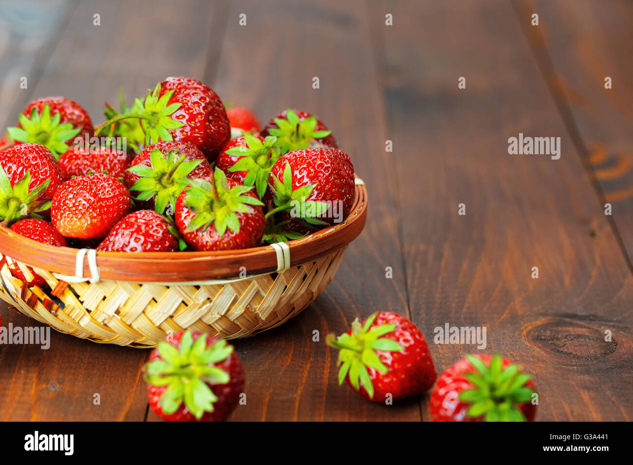 Very beautiful background with fresh strawberries in a wicker round ...