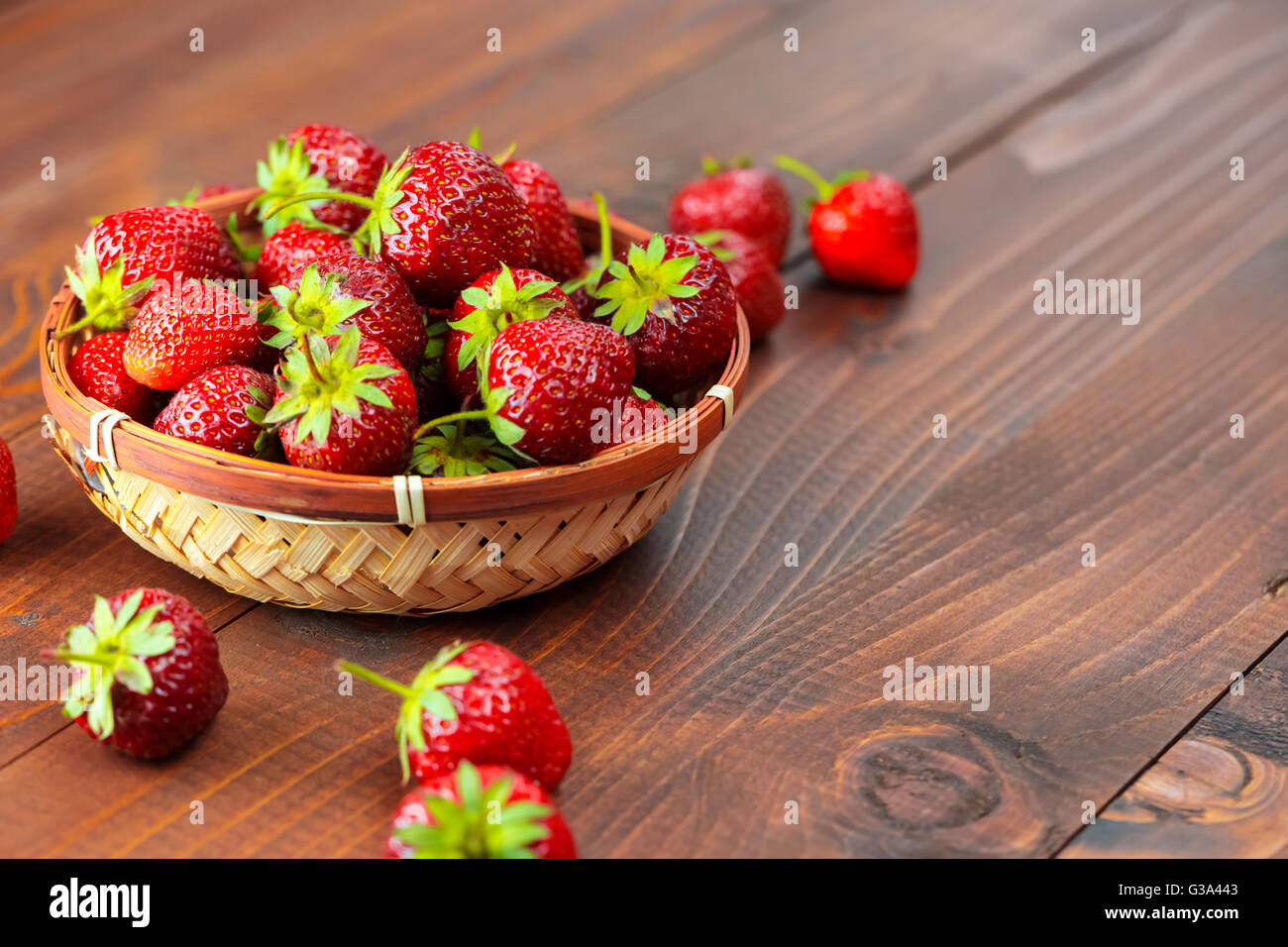 Very beautiful background with fresh strawberries in a wicker round ...