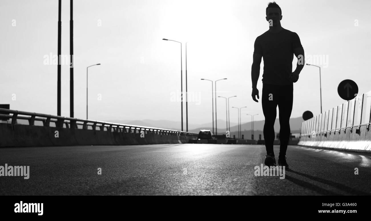 Running at sunrise man exercising for marathon and workout fitness ...